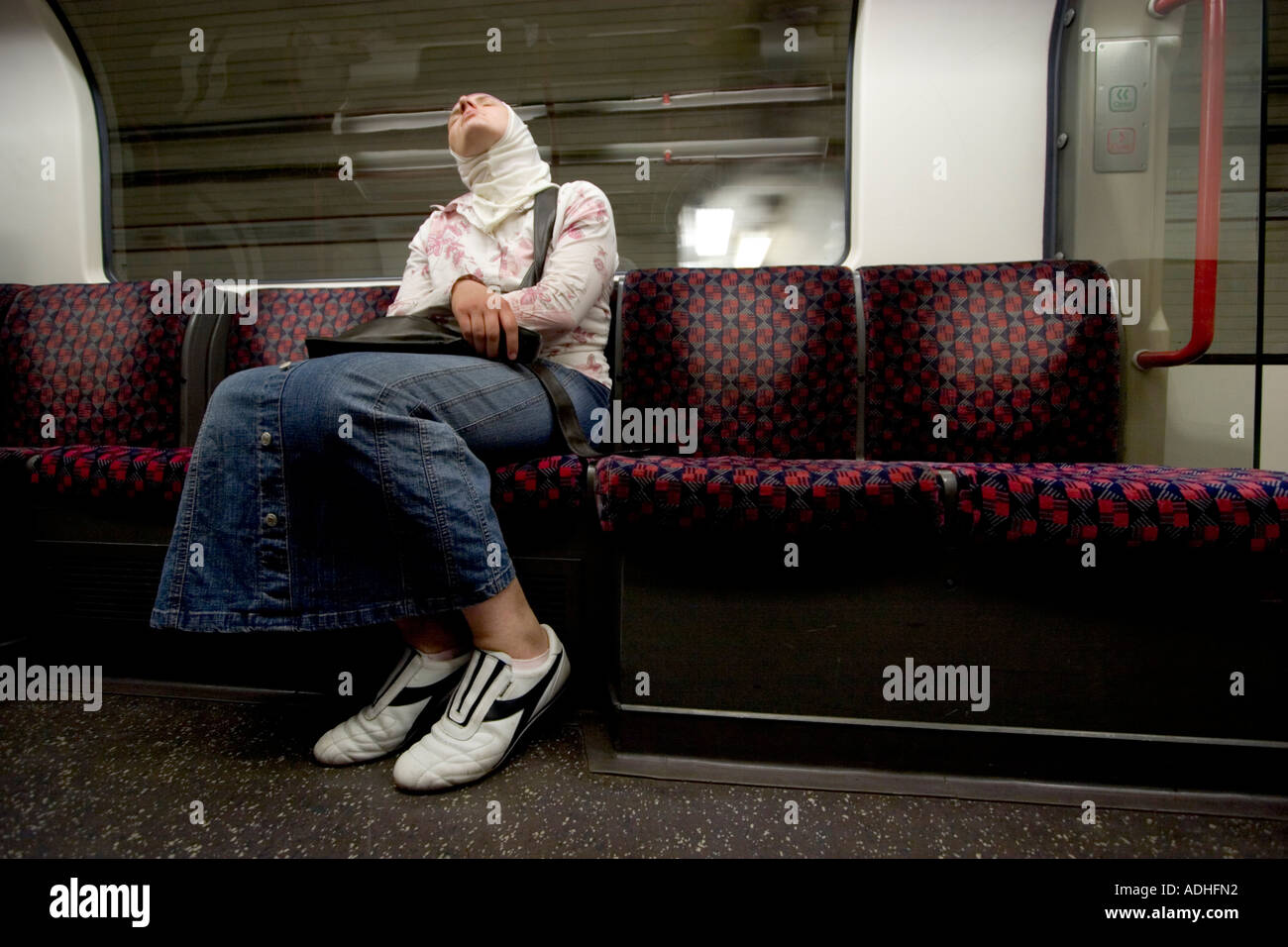 London underground tube network station young person asleep on train ...