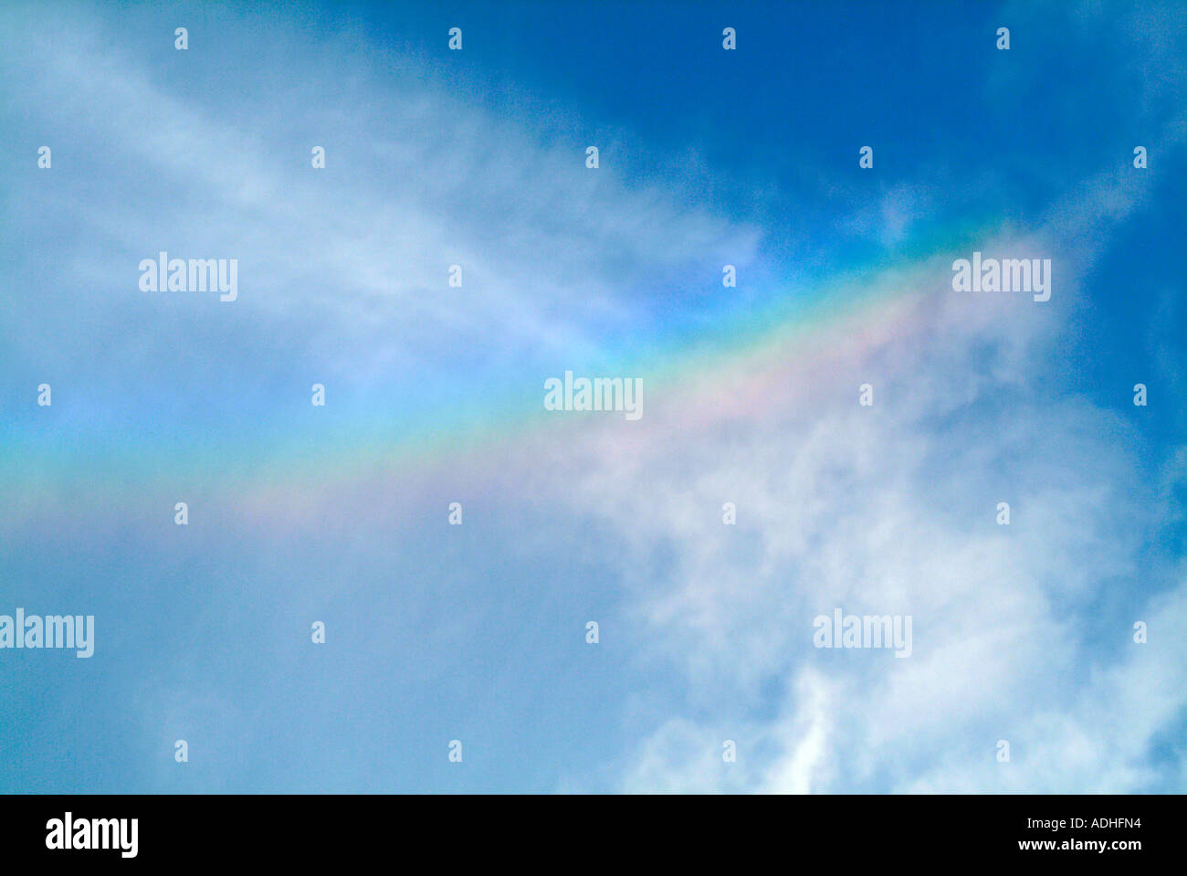 Rainbow Effect in Cirrus Cloud in Blue Sky Over Cheshire England Stock ...