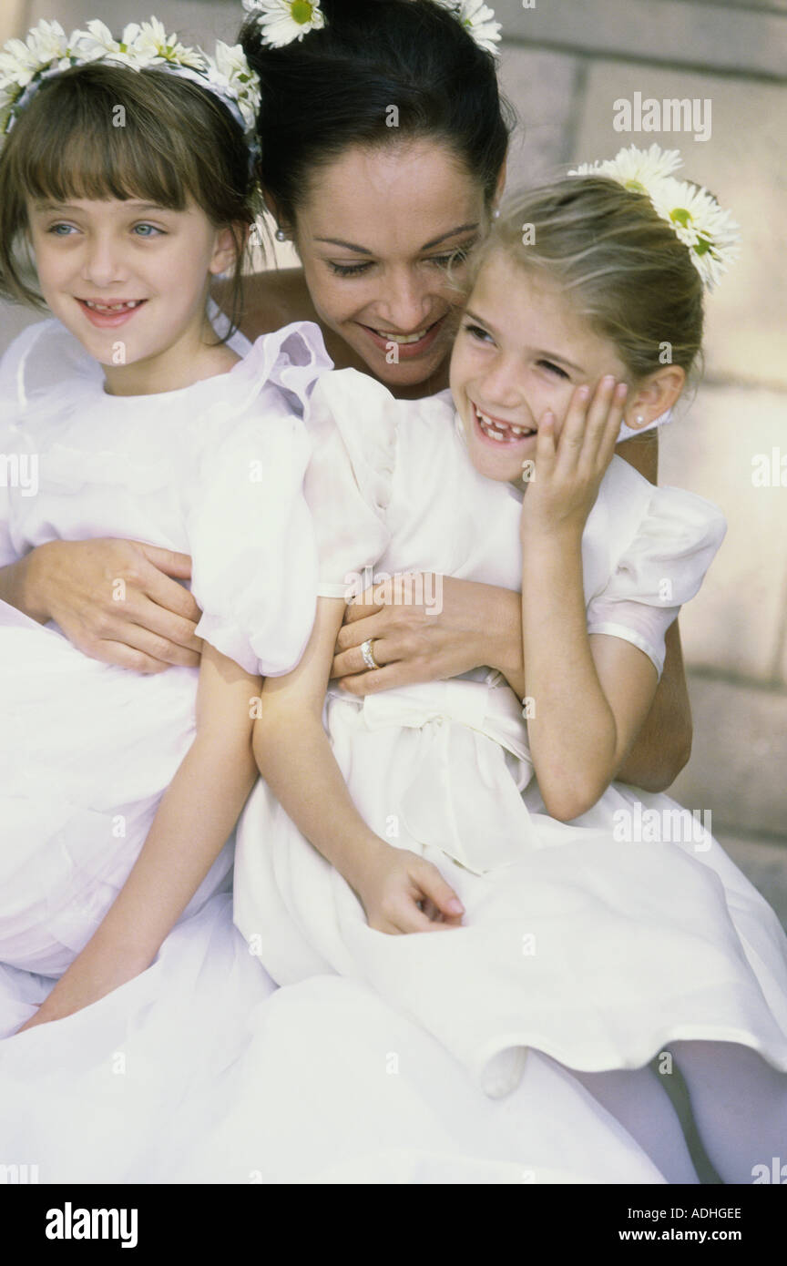 Bride hugging two flower girls Stock Photo - Alamy