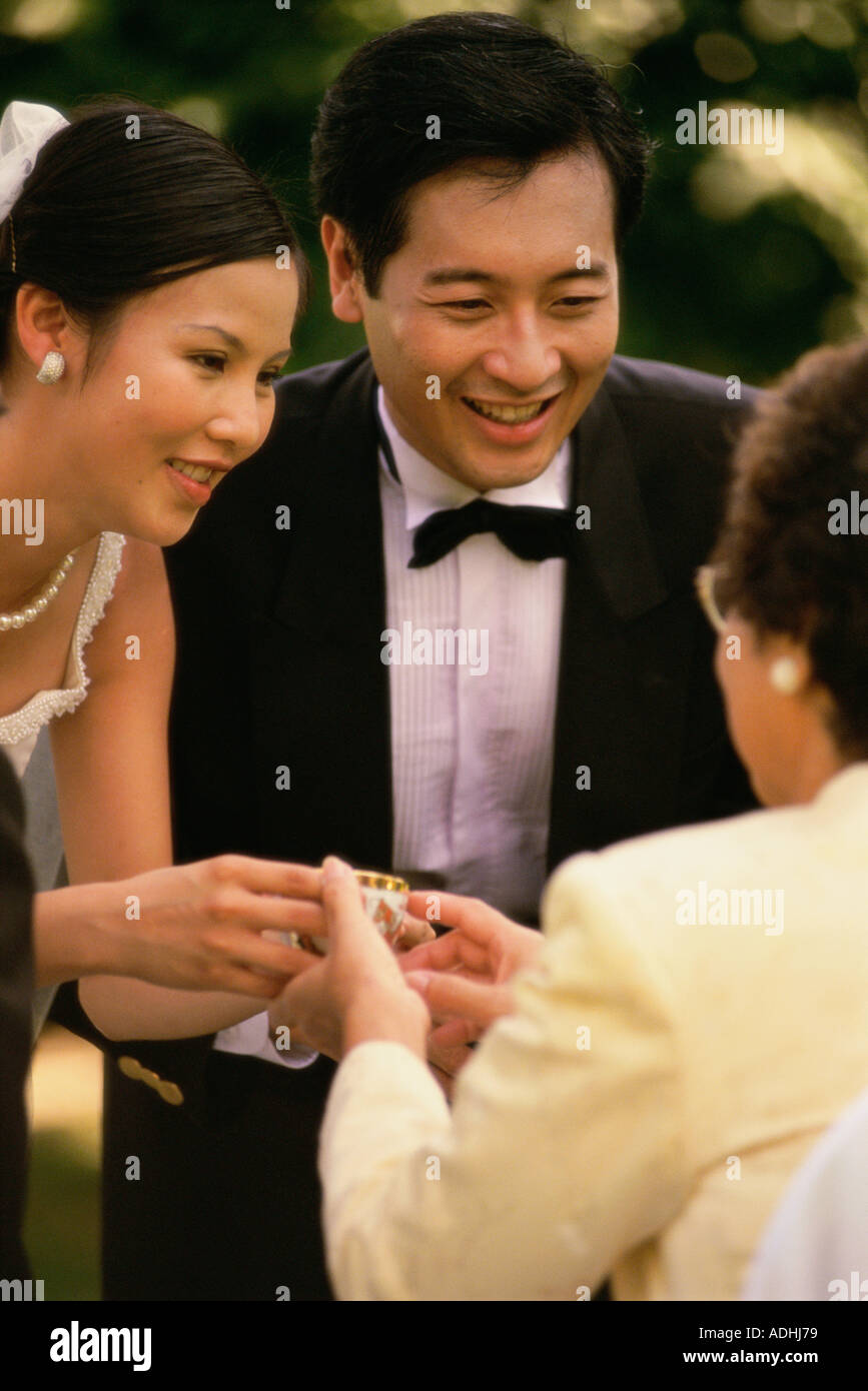Bride offering tea to her mother Stock Photo - Alamy
