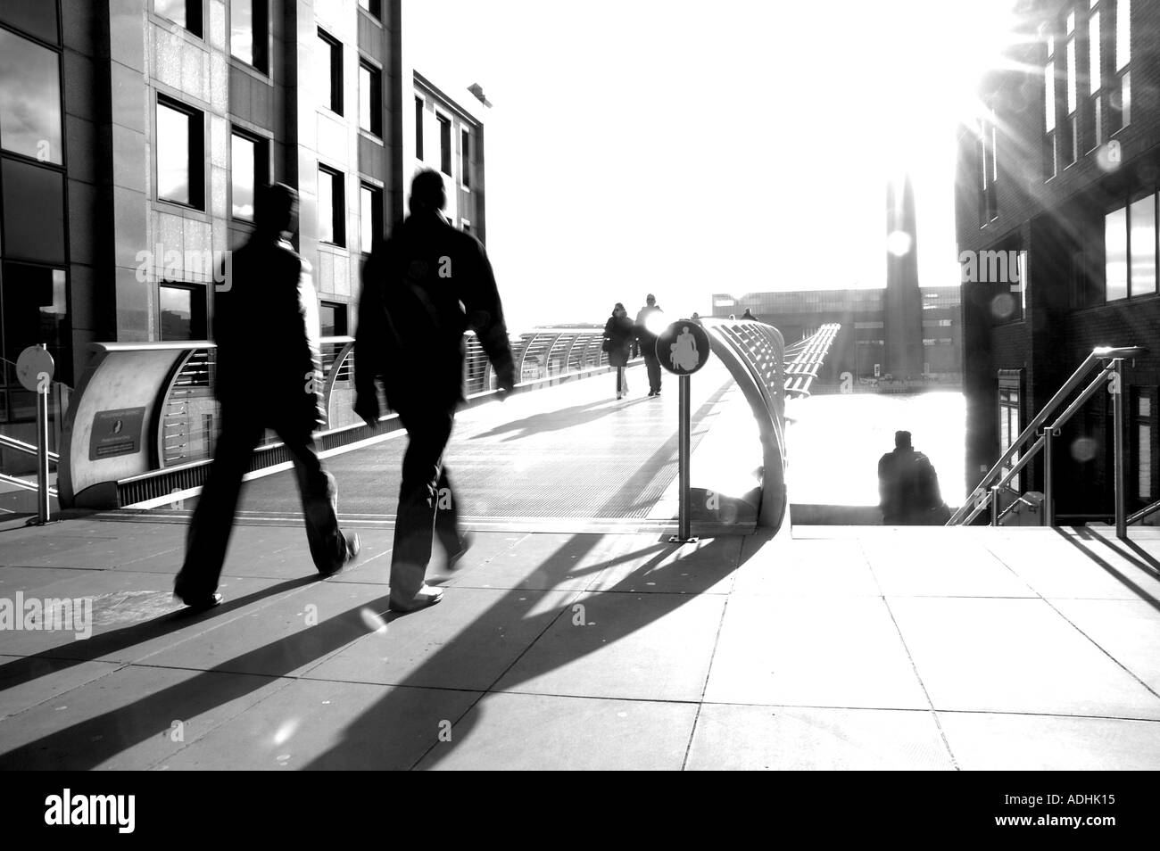 Pedestrians walking over the Millenium Bridge with Tate Modern in the ...