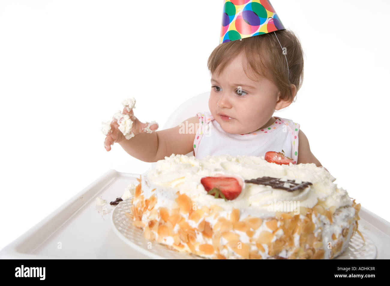 One year old baby girl eating from her birthday cake Stock Photo - Alamy