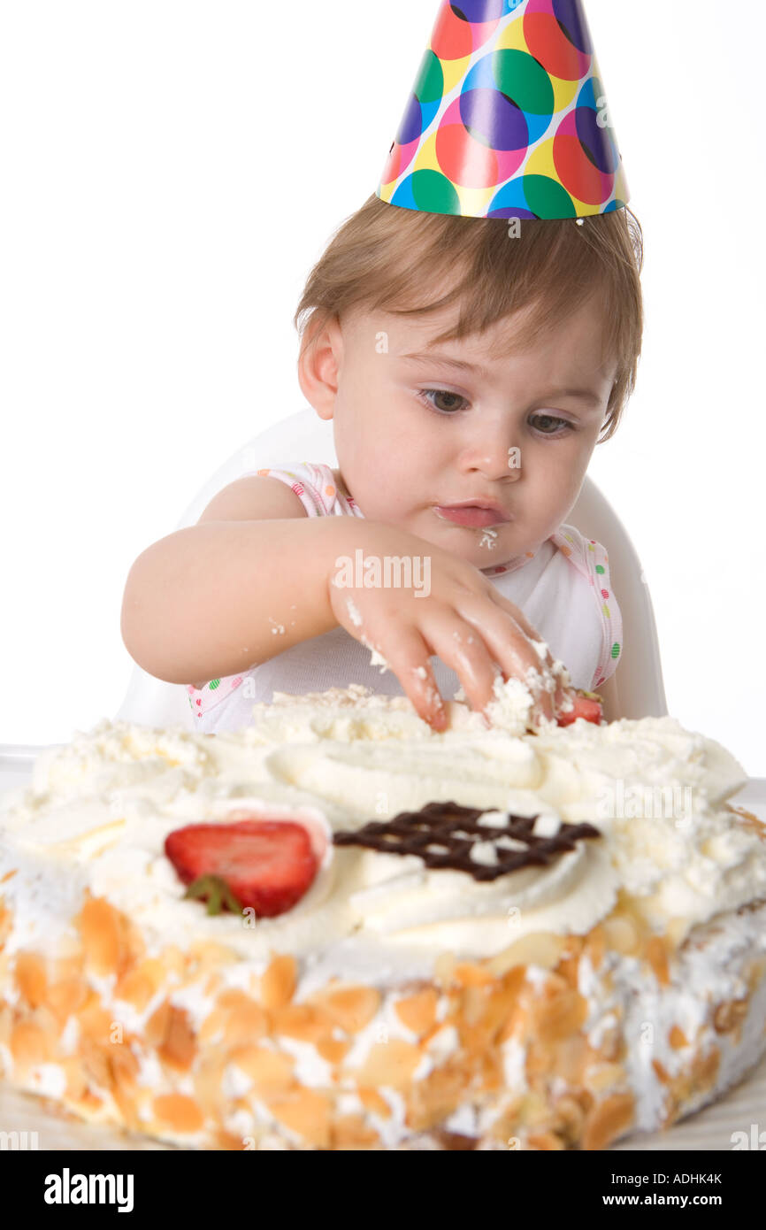 One year old baby girl eating from her birthday cake Stock Photo - Alamy
