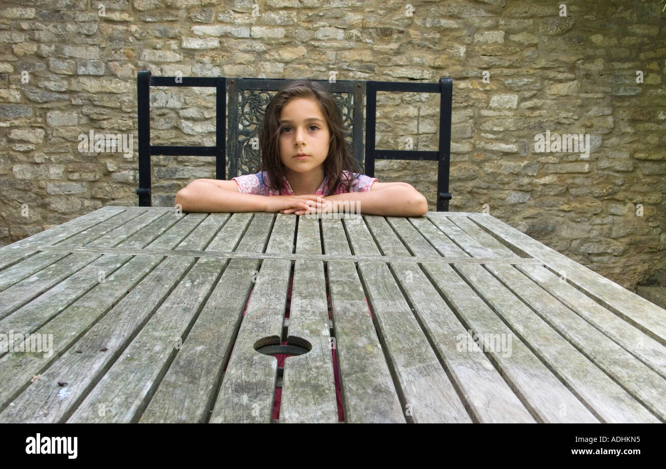 young girl sitting at end of table in walled garden model released ...