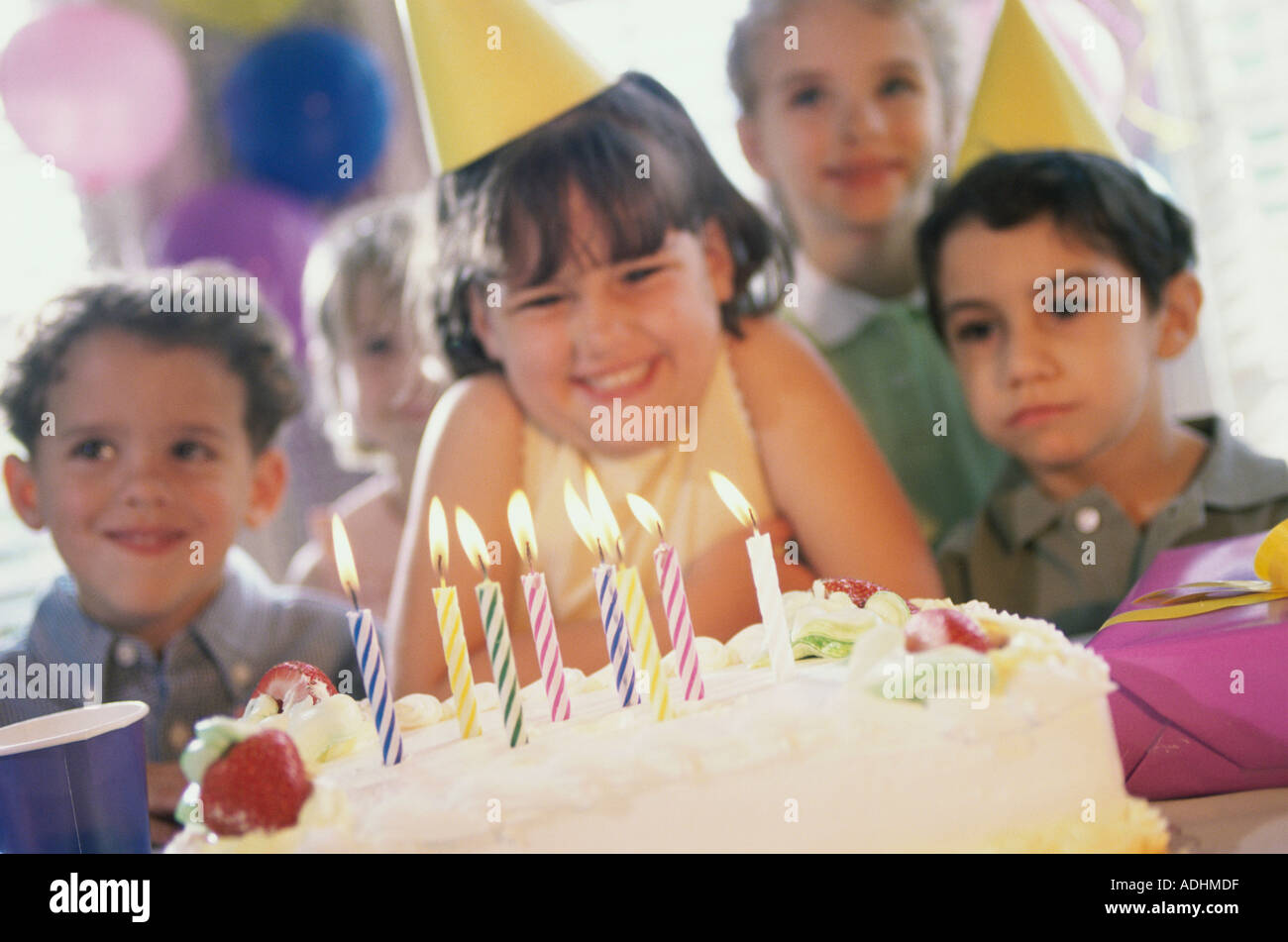 Group of children in front of a birthday cake at a birthday party Stock ...