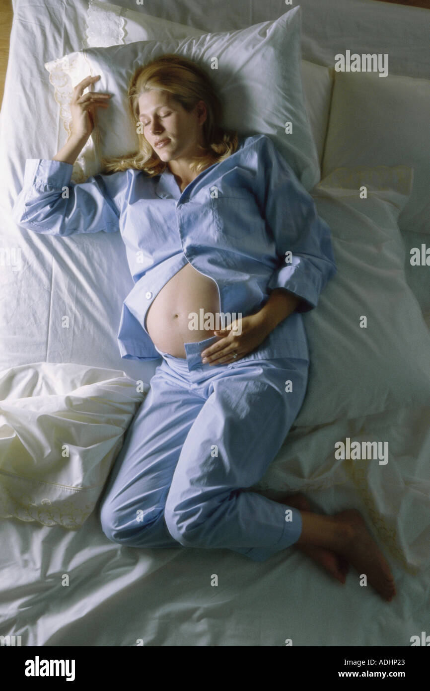 High angle view of a pregnant woman sleeping on a bed Stock Photo - Alamy