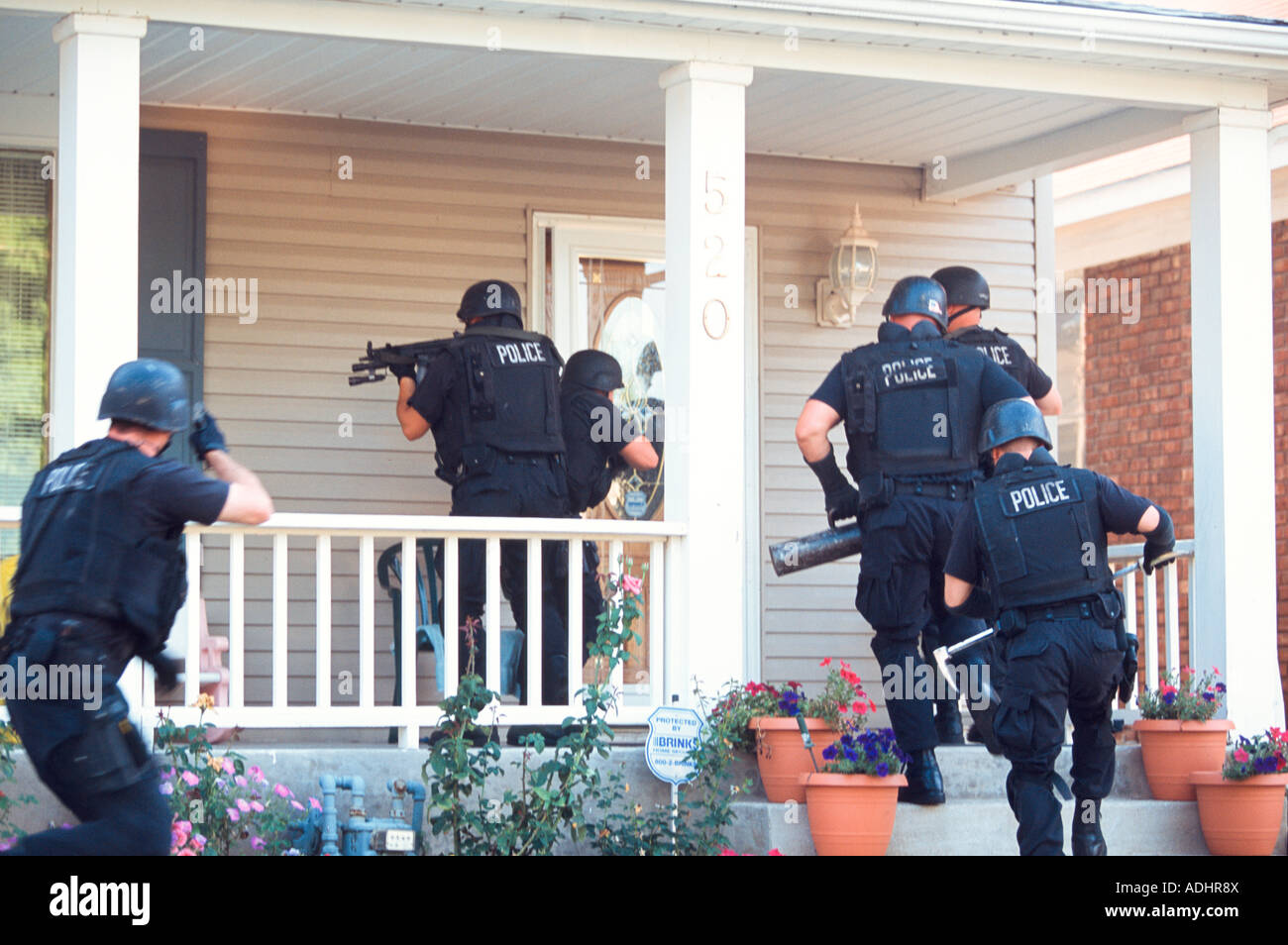 Tactical police team from Street Narcotics Unit serving high risk drug ...