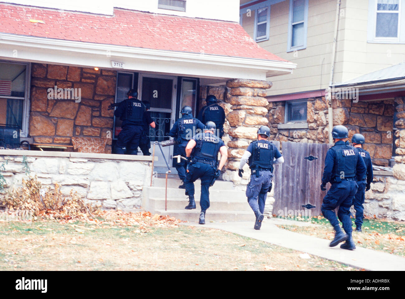 Tactical police team from Street Narcotics Unit serving high risk drug ...