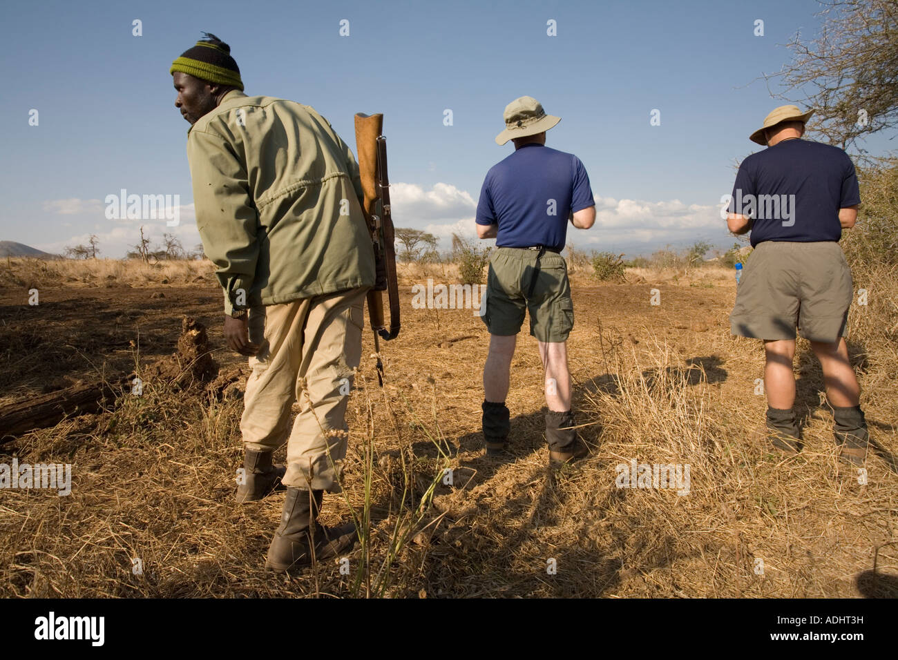 Africa Tanzania Armed park ranger surveys surroundings during ...
