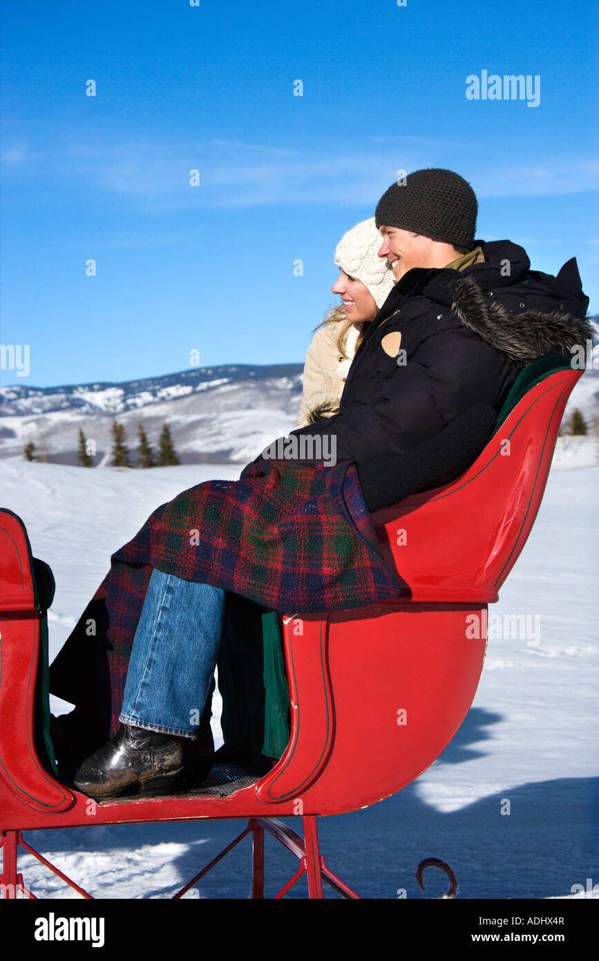 Mid adult Caucasian couple riding in a sleigh Stock Photo - Alamy