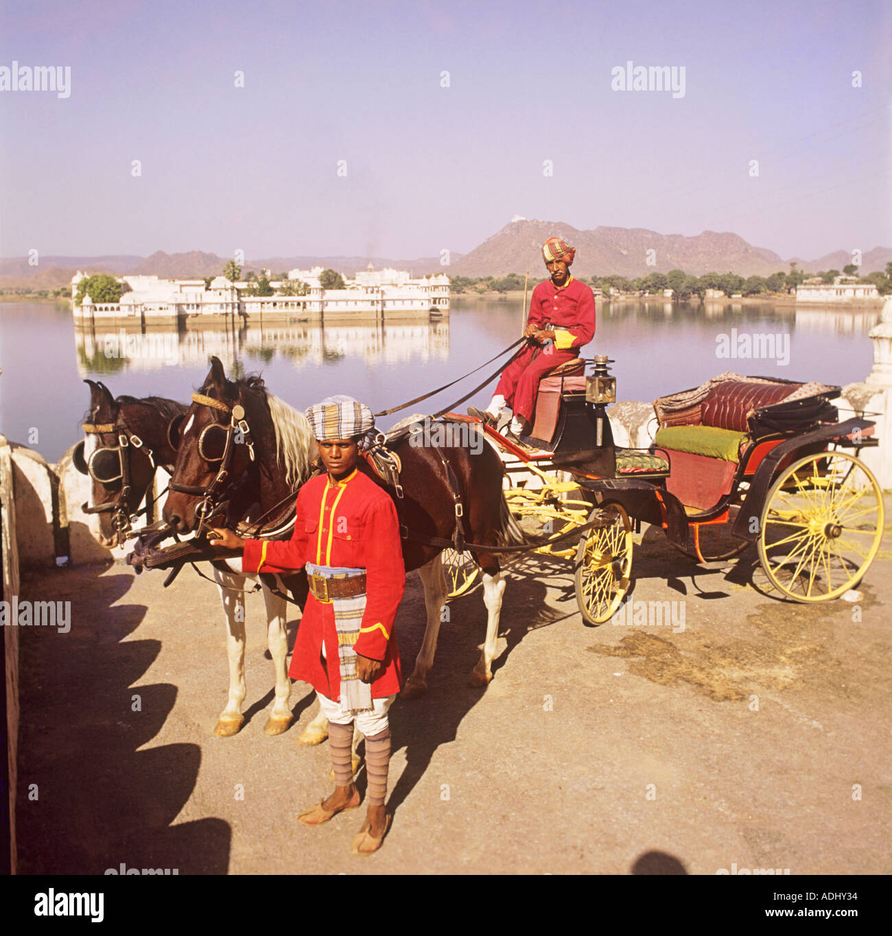 A liveried coach and pair await guests at the Udaipur Hotel in India ...