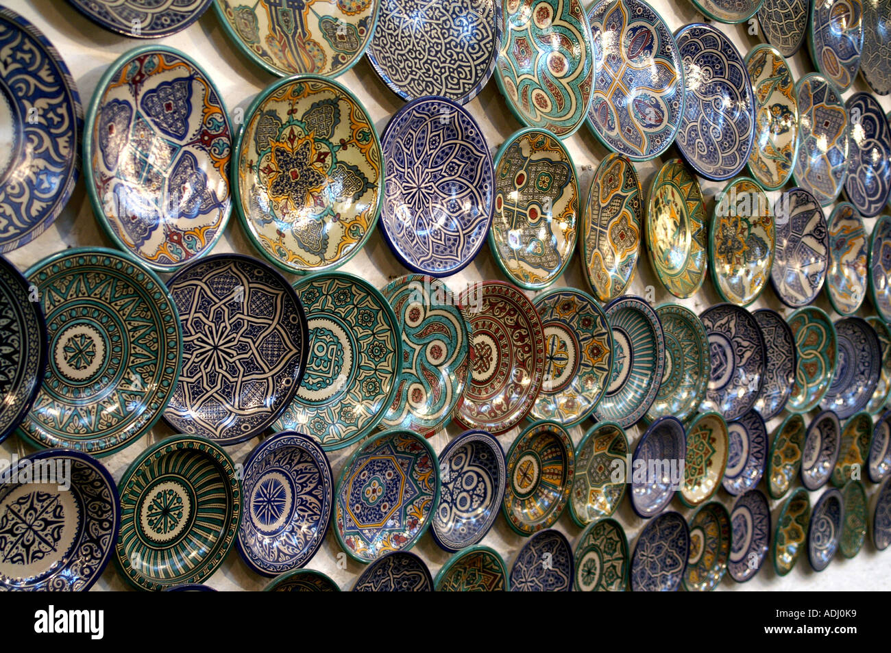 Hand painted decorated plates on display at the ceramic clay works shop ...