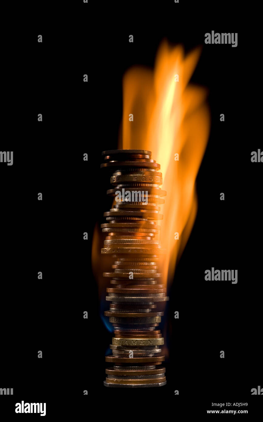 Coins on fire Stock Photo - Alamy