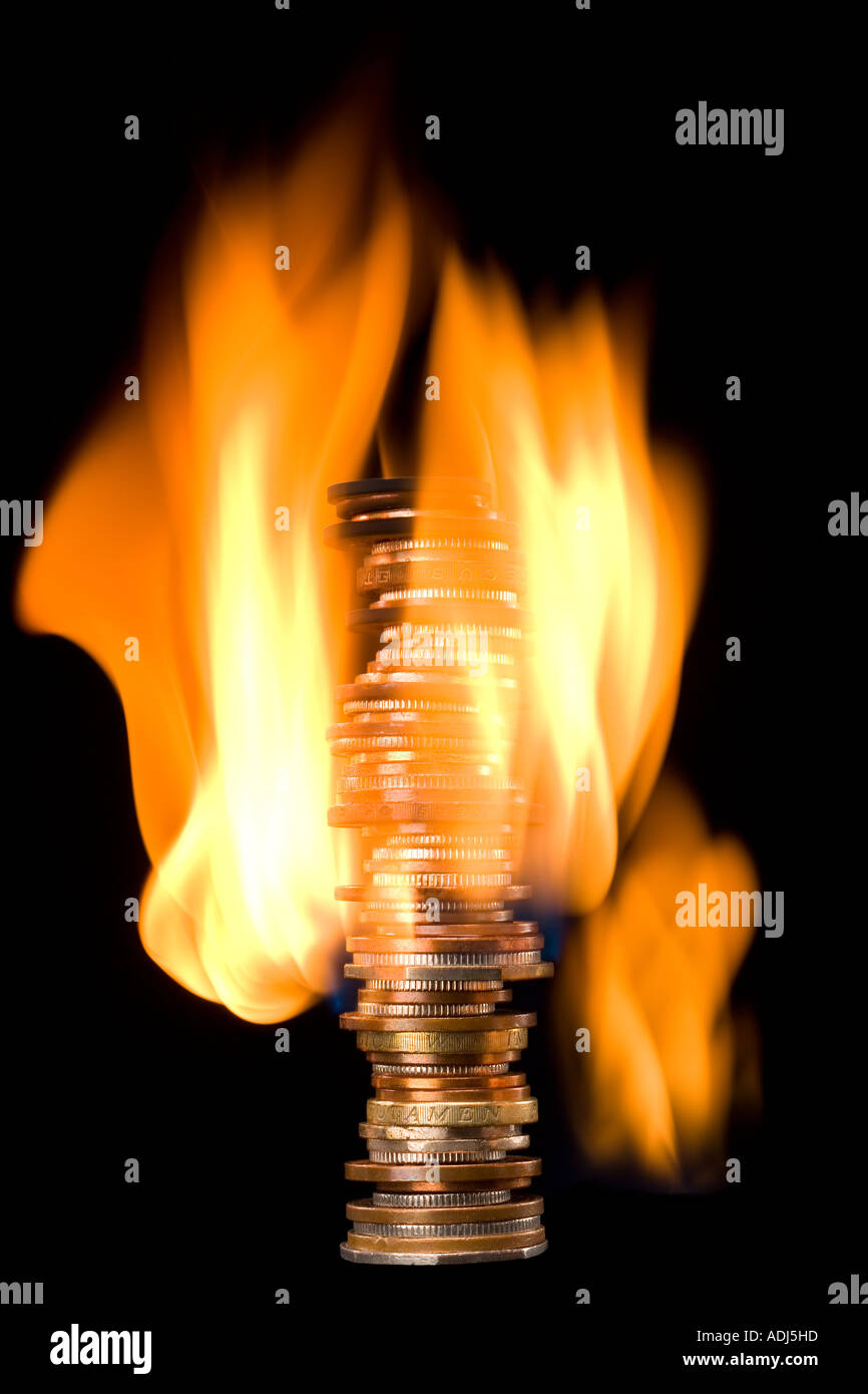 Coins on fire Stock Photo - Alamy