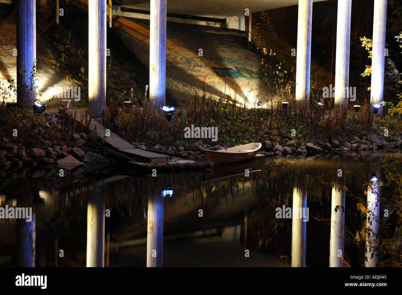 Illuminated river scene under road bridge at the Jyvaskyla Festival of ...