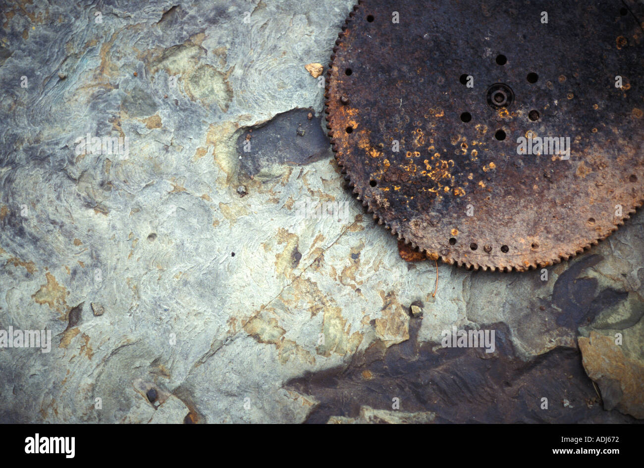 Rusting gear wheel on flat stone Stock Photo - Alamy