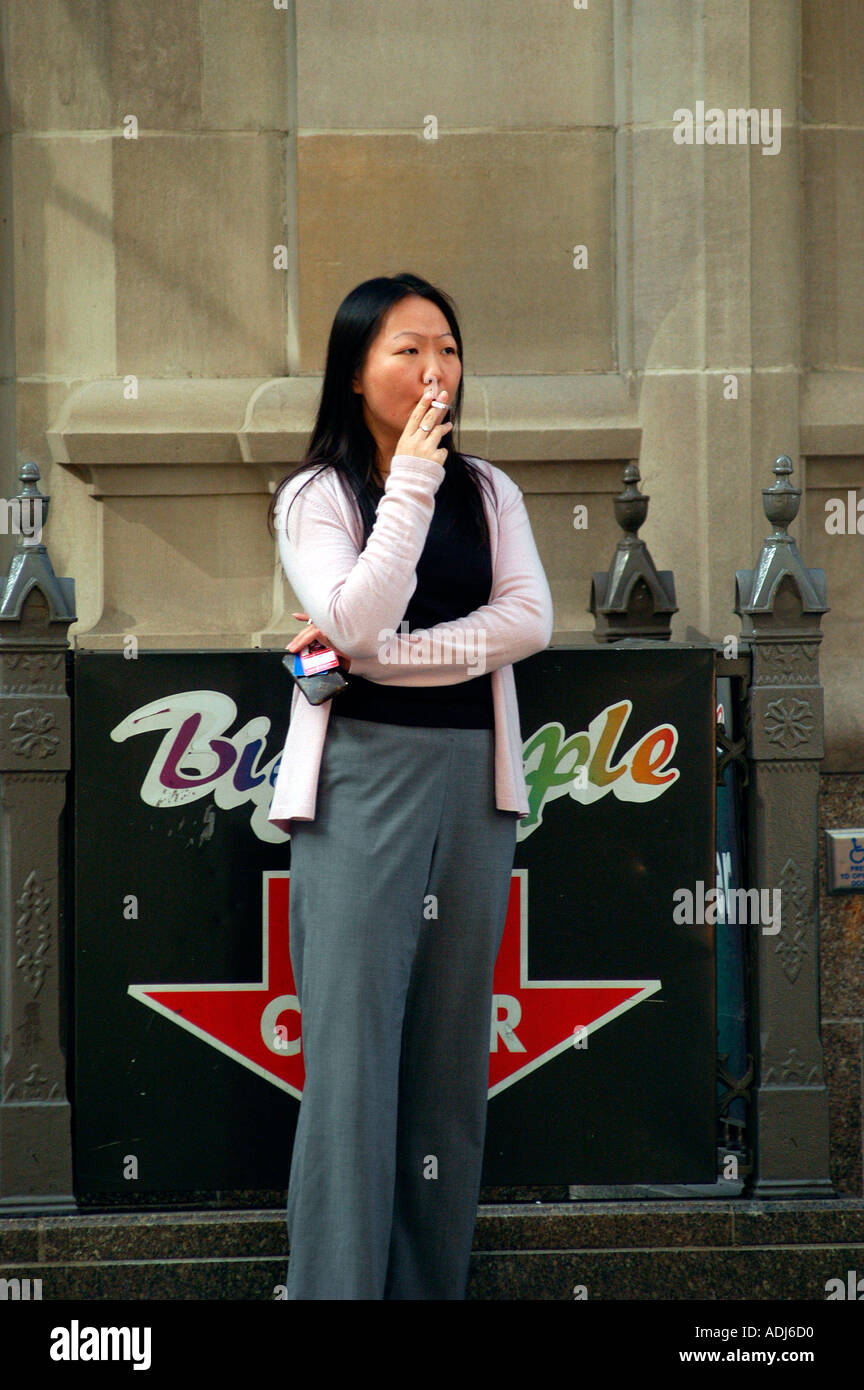 Woman smoking outside office building hi-res stock photography and ...