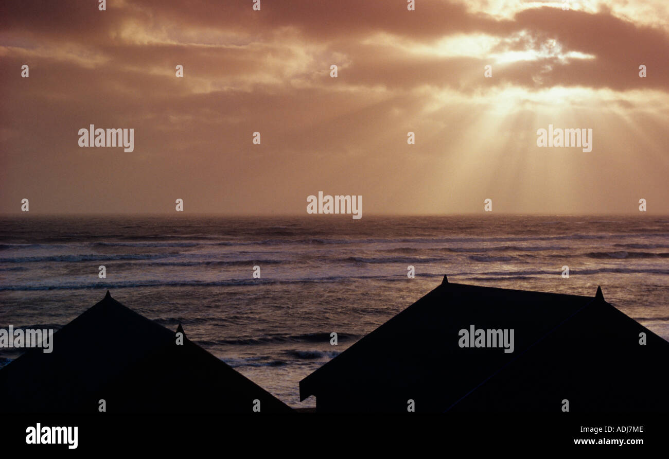 cloudy sunset over beach huts in silhouette at Milford on sea, New ...