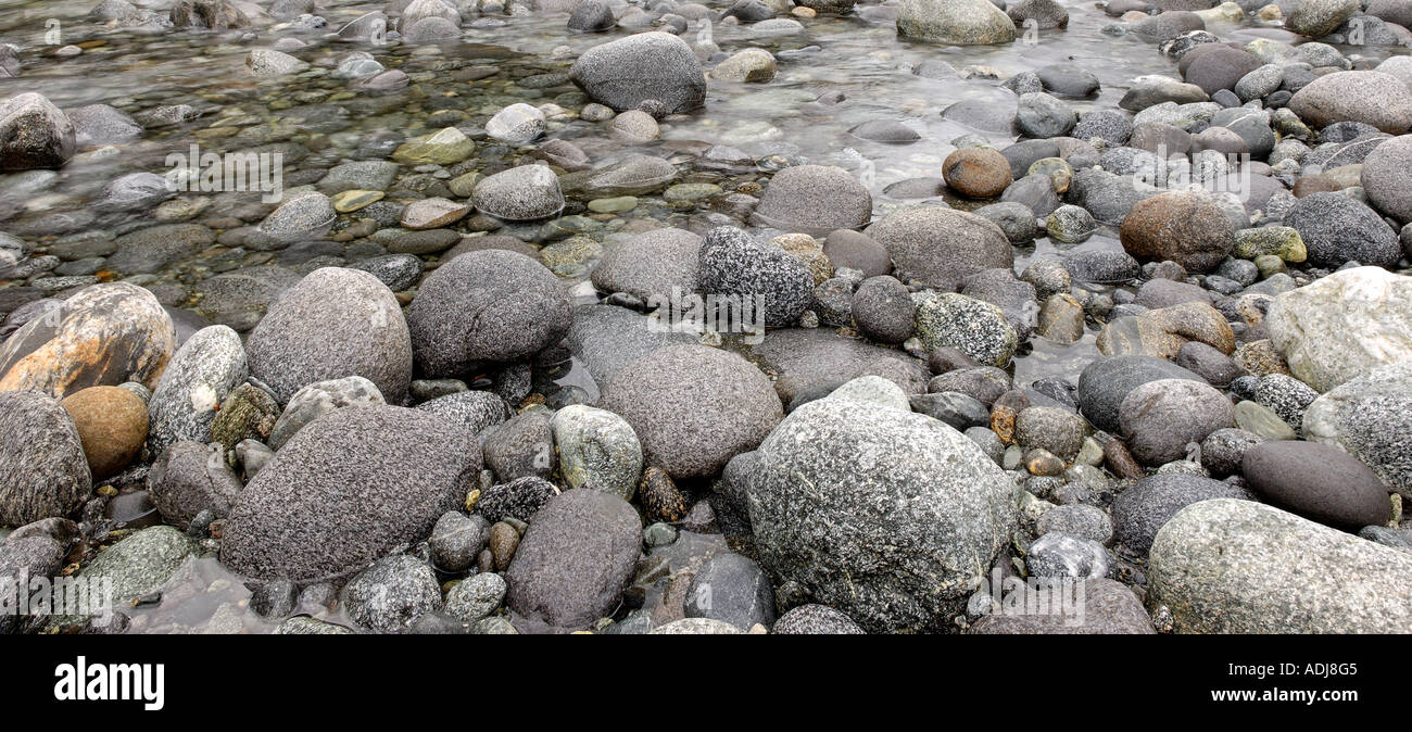 A panoramic view of different coloured river rocks in a creek bed Stock ...
