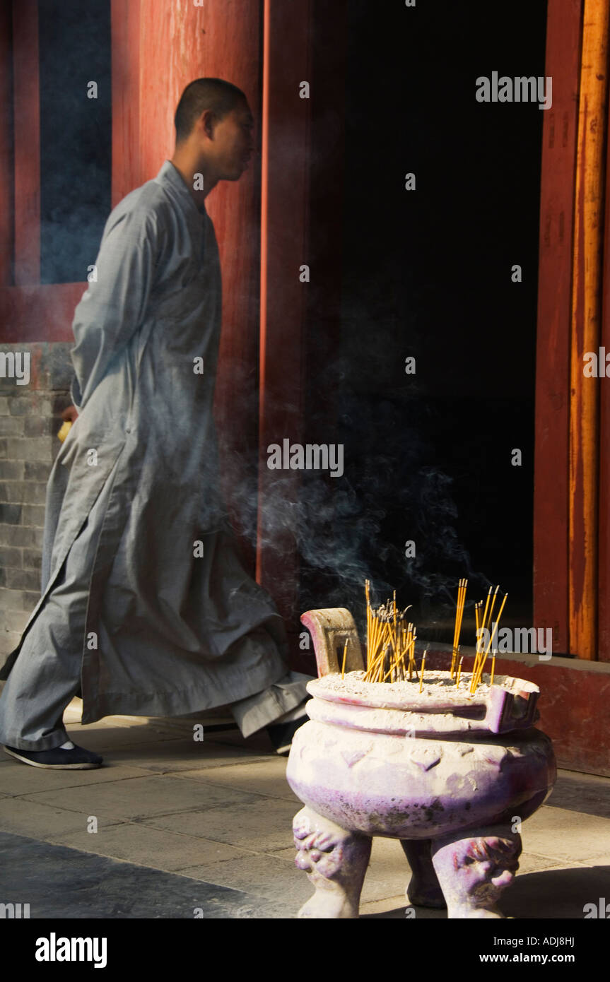 a temple monk and incense sticks burning at Shaolin Temple birthplace ...