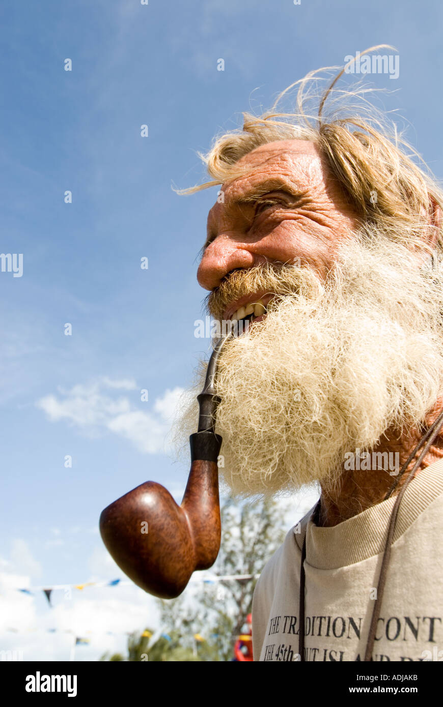 GREAT EXUMA BAHAMA GEORGE TOWN Mature man in full beard puffing on ...