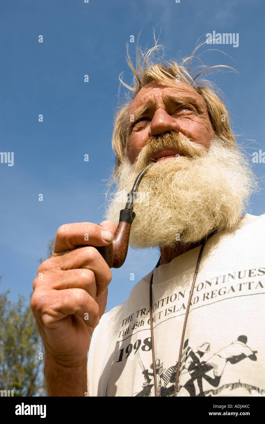 GREATER EXUMA BAHAMA GEORGE TOWN Mature man in full beard puffing on ...