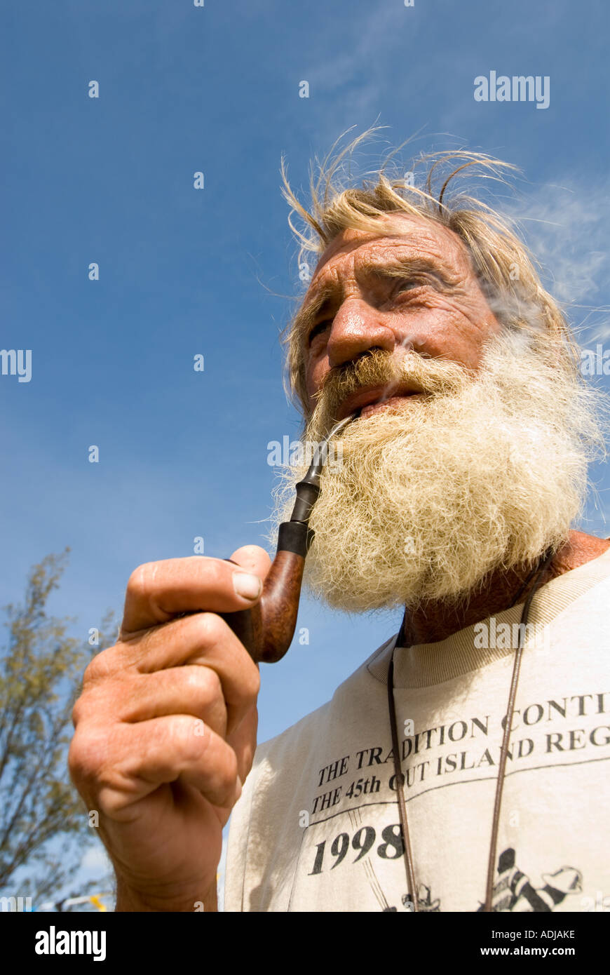 GREATER EXUMA BAHAMA GEORGE TOWN Mature man in full beard puffing on ...