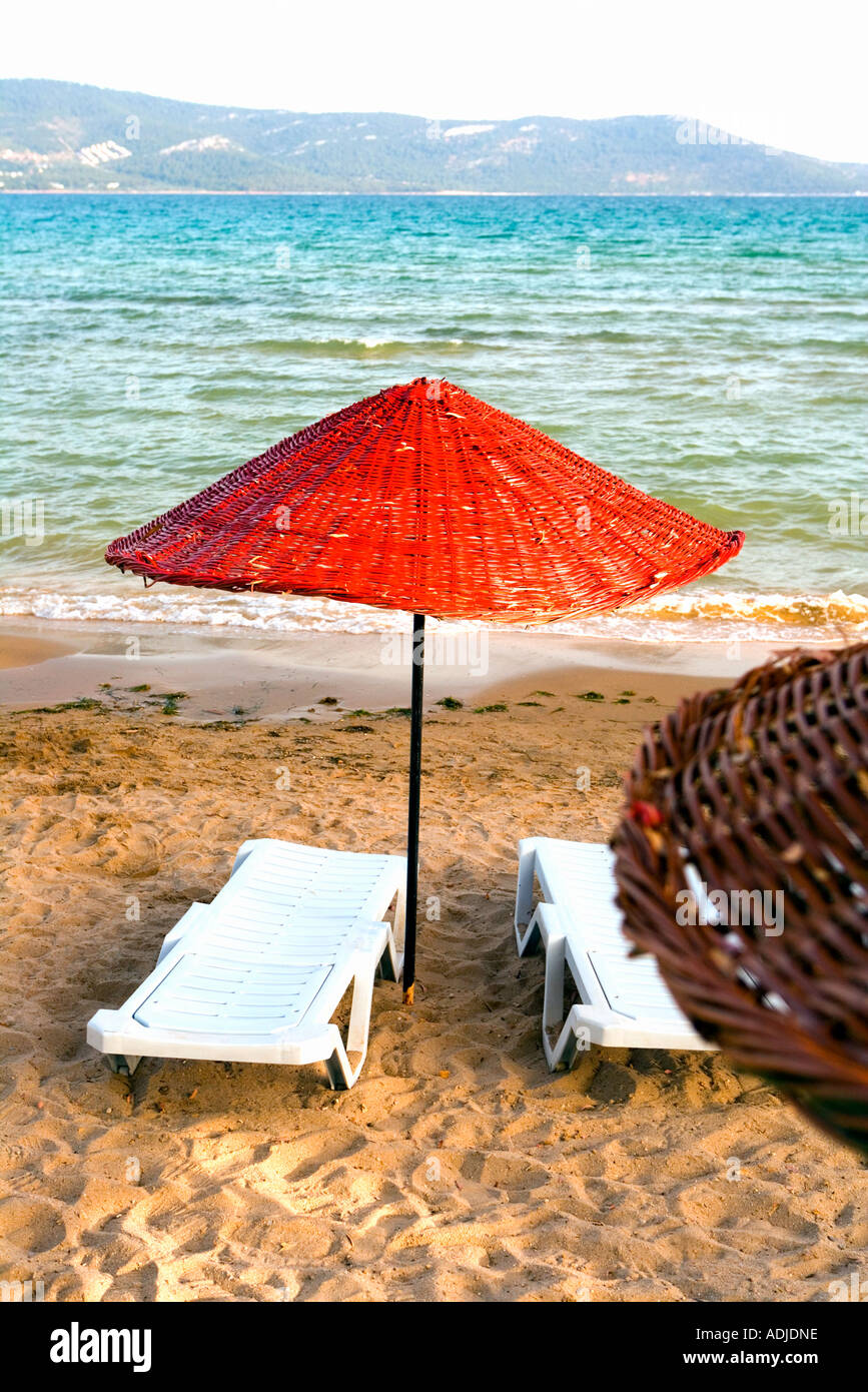 Sun loungers and red beach-shade Altinkum Turkey late afternoon Stock ...