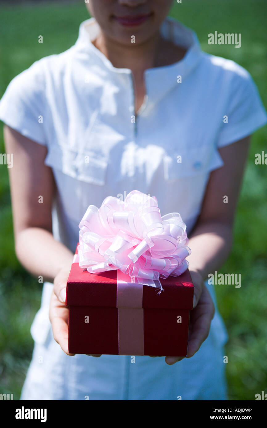 a woman giving a present Stock Photo - Alamy
