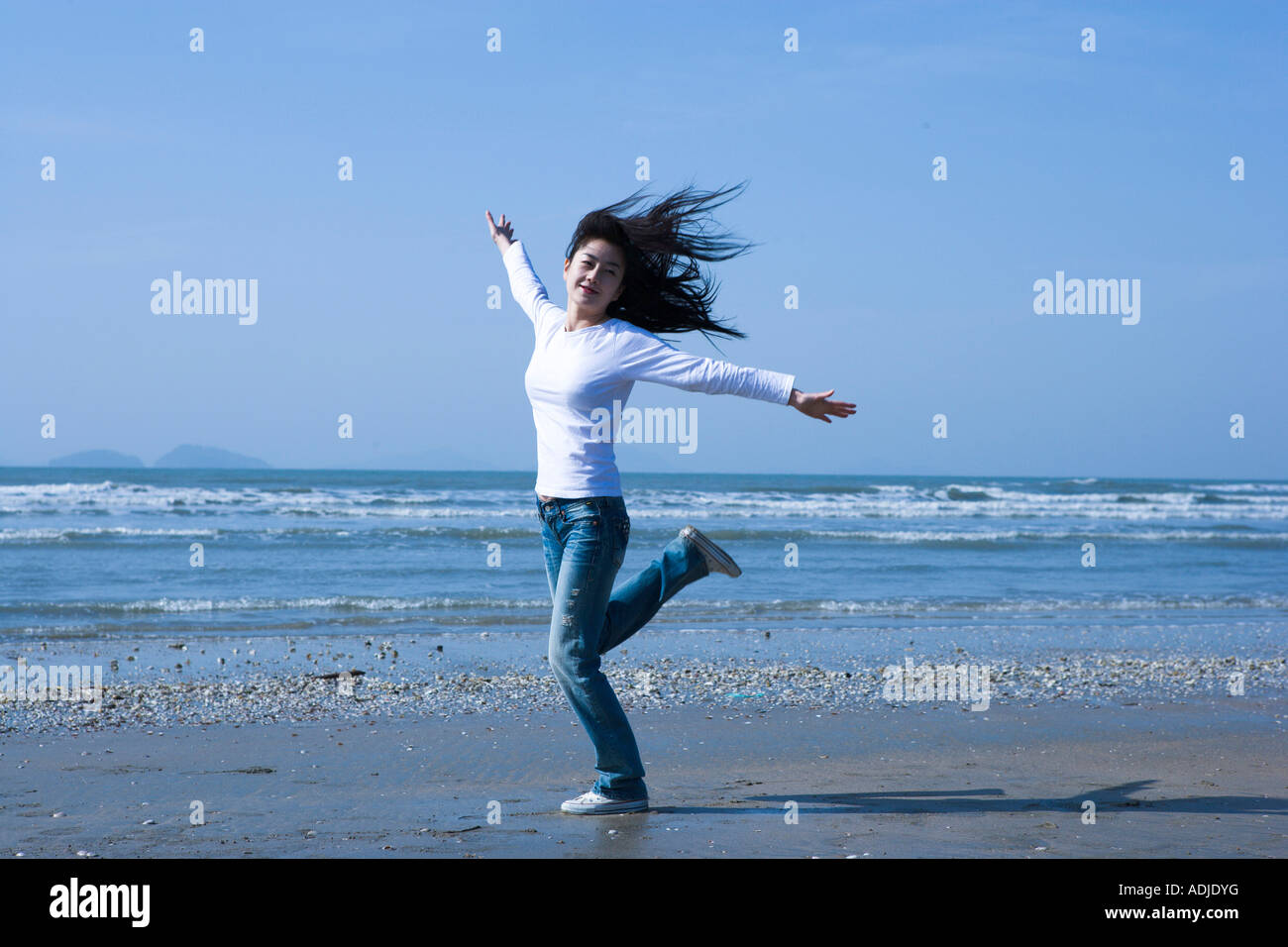 a woman running in a seashore Stock Photo - Alamy