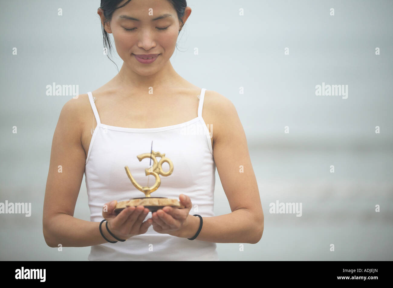 a woman holding an incense burner Stock Photo - Alamy