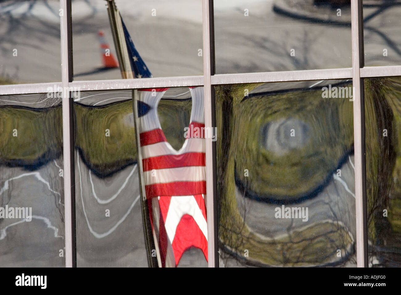 American flag reflected in the windows of an office building Stock ...