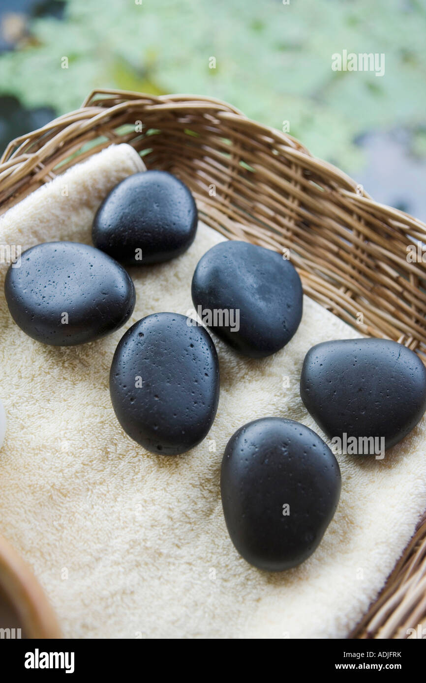 spa pebbles on a basket Stock Photo - Alamy