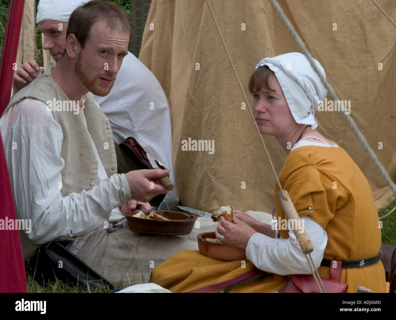 medieval couple sitting eating Stock Photo - Alamy