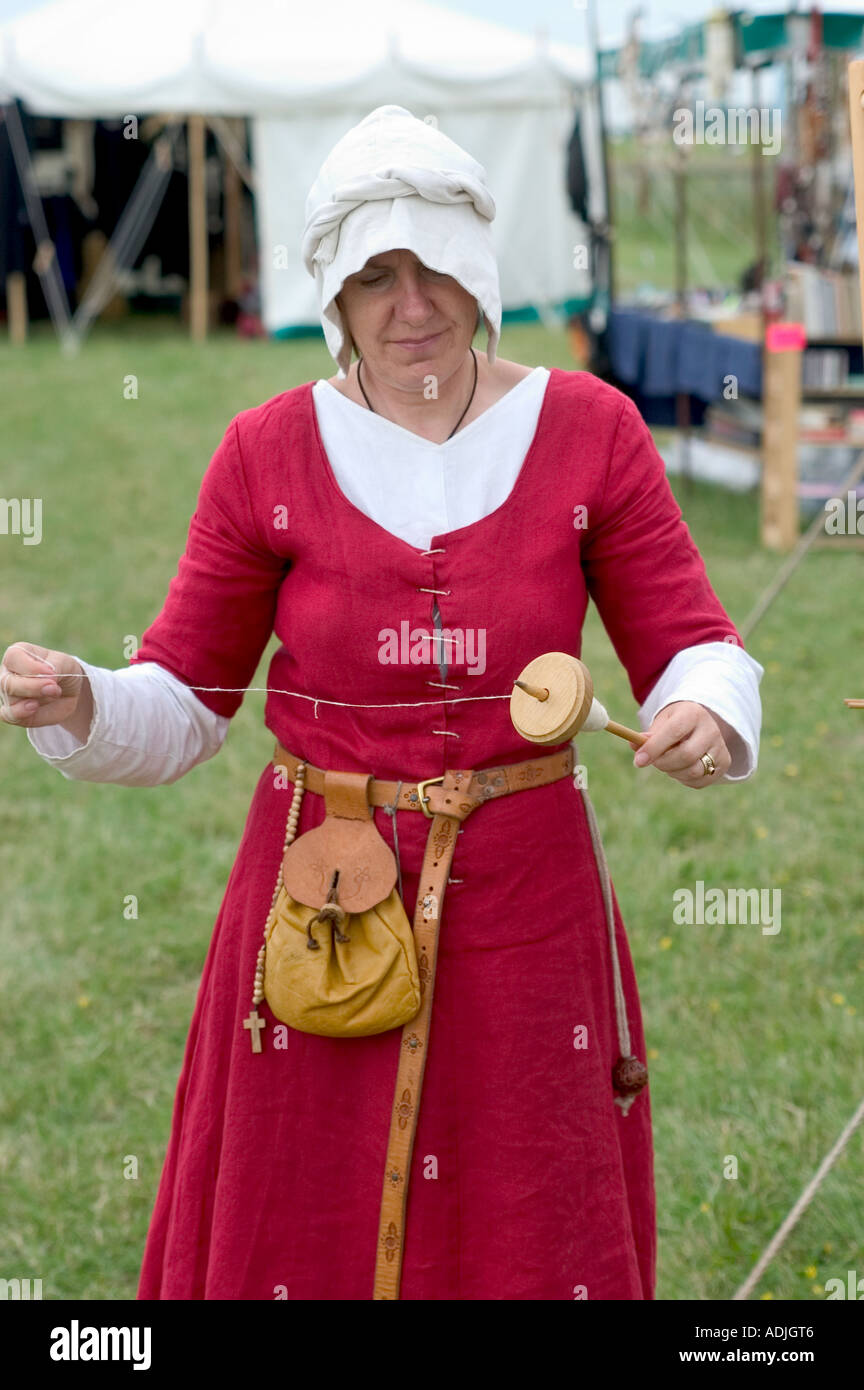 woman spinning thread in medieval costume at a fair Stock Photo - Alamy