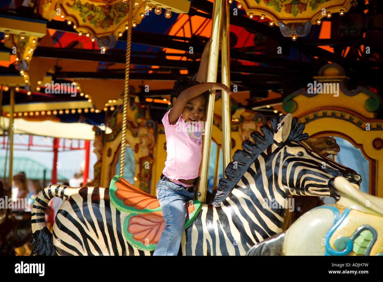 CHICAGO Illinois African American girl ride zebra at carousel amusement ...