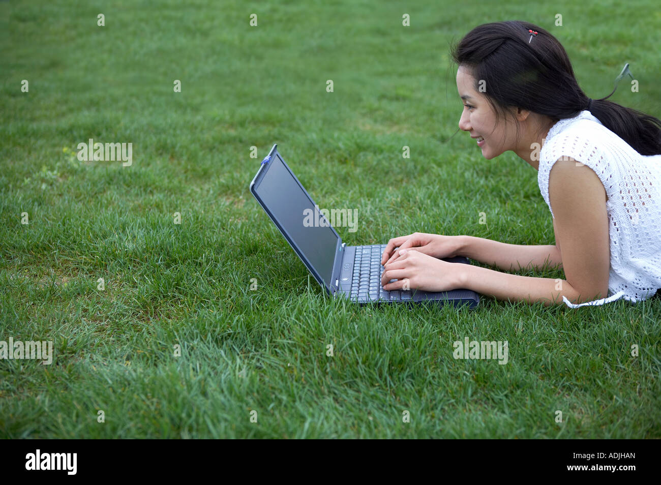 woman with computer on the grass field Stock Photo - Alamy