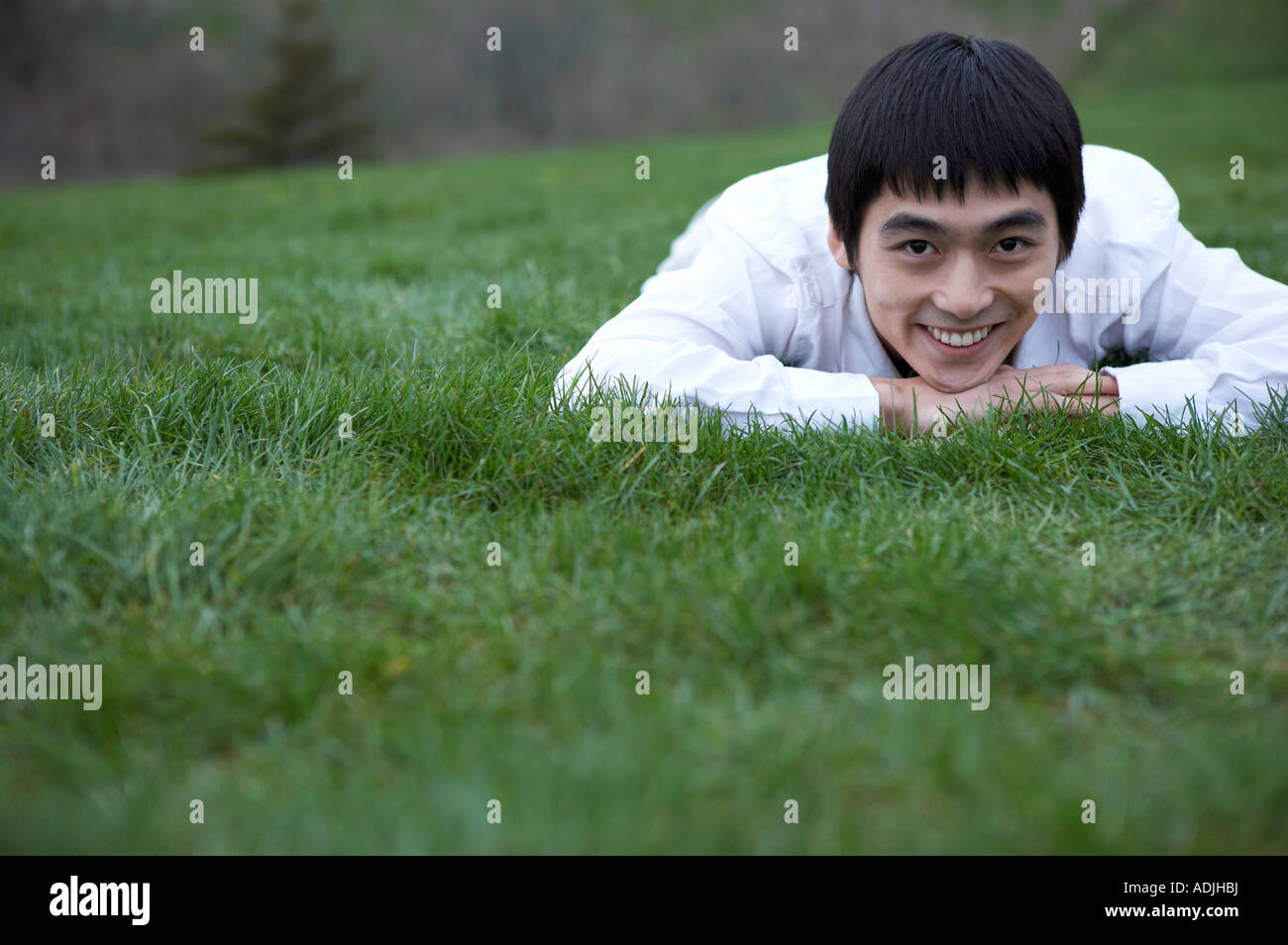 rest grass field lying prone man Stock Photo - Alamy