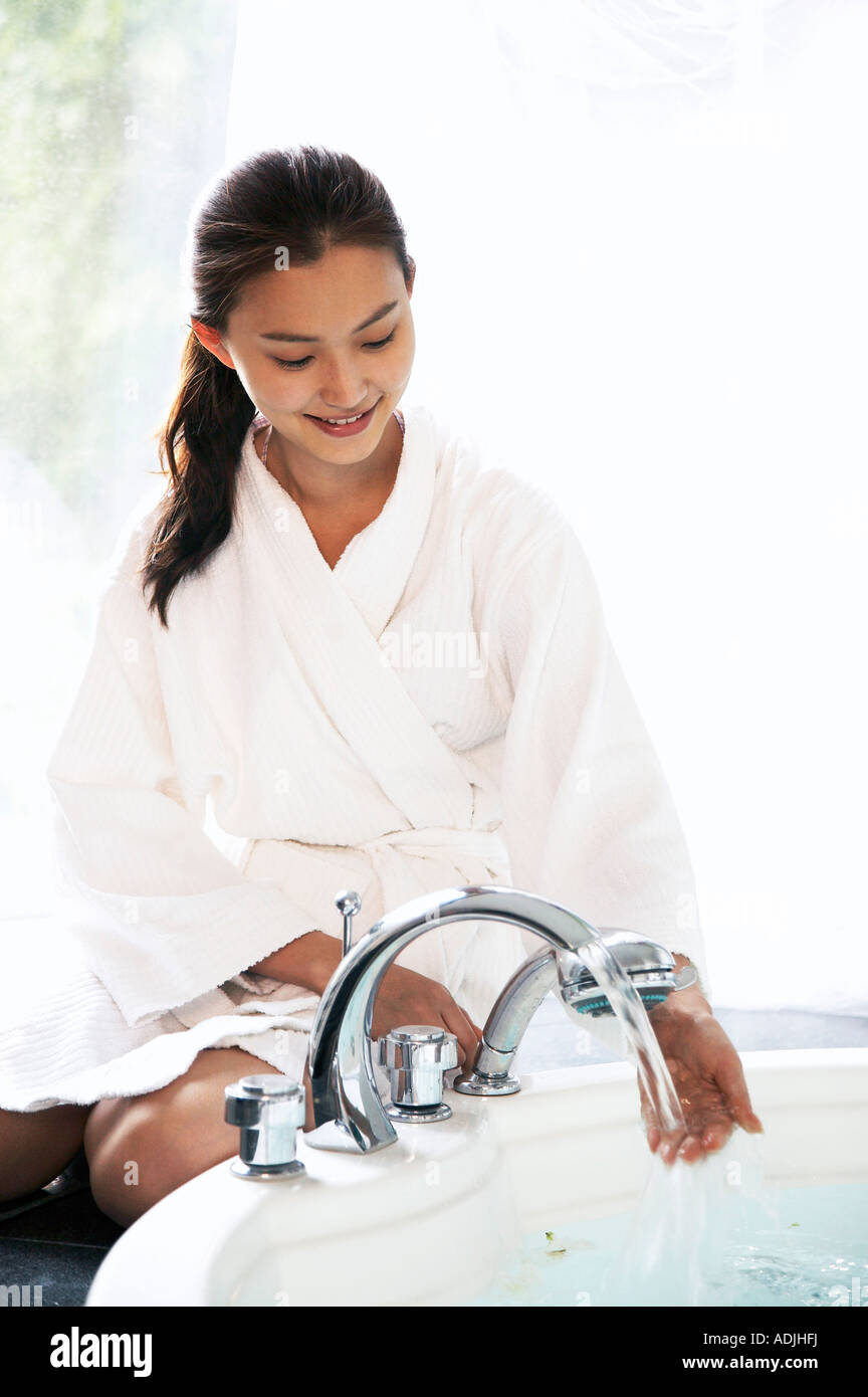 woman checking temperature of the water of the bath tub Stock Photo - Alamy