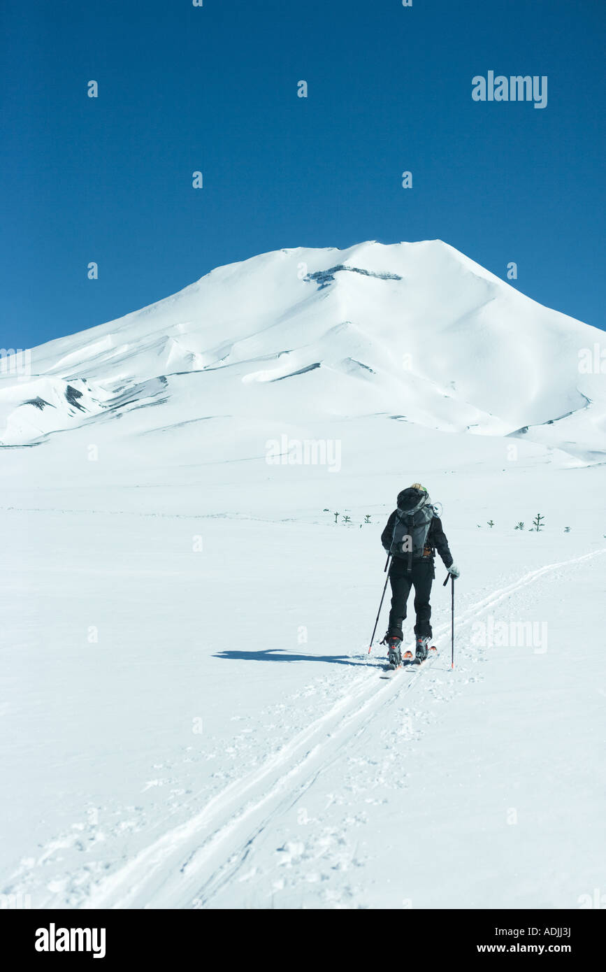 Skier heading toward mountain, rear view Stock Photo - Alamy