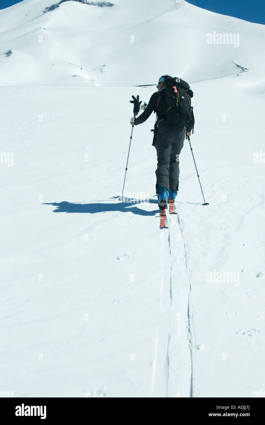 Skier heading toward mountain, rear view Stock Photo - Alamy