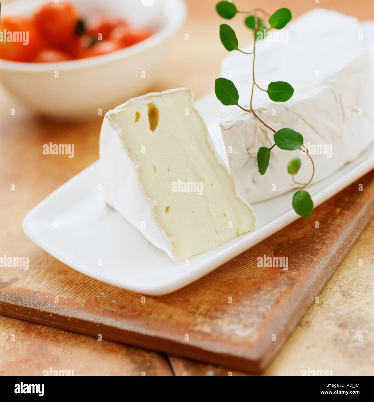 brie cheese plate buds cheese dairy food tomato Stock Photo - Alamy