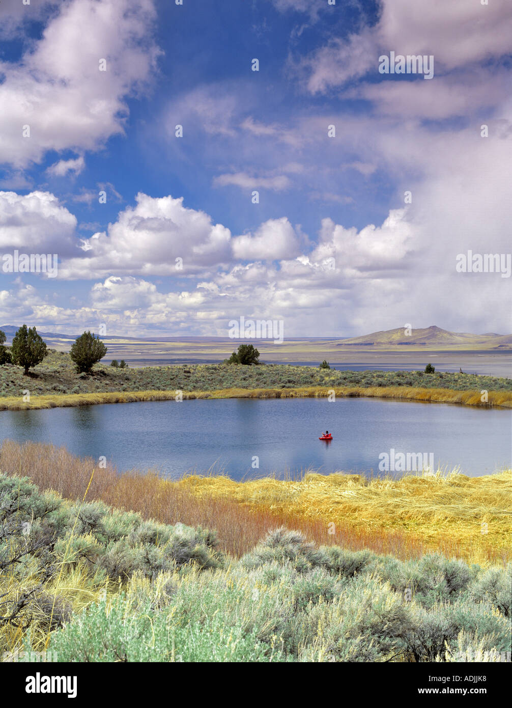 Fly fisherman in float tube on small pond on Hart Mountain Oregon Stock ...