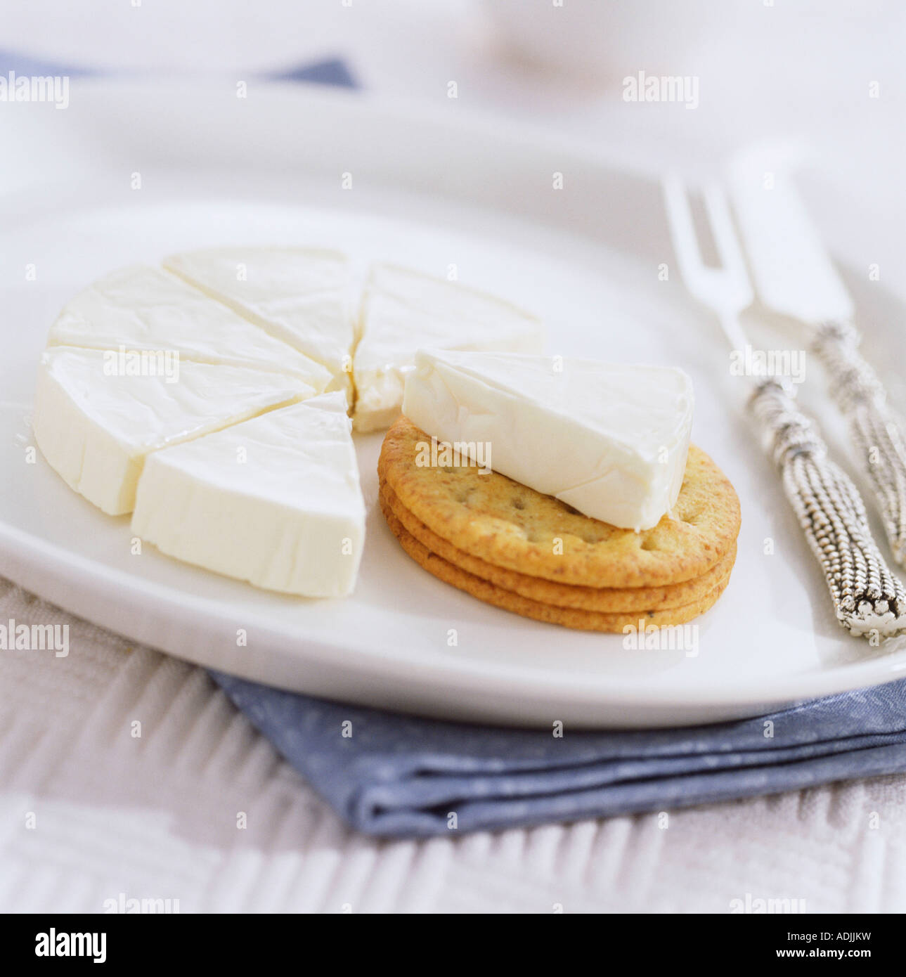 brie cheese cracker fork knife plate dish piece Stock Photo - Alamy