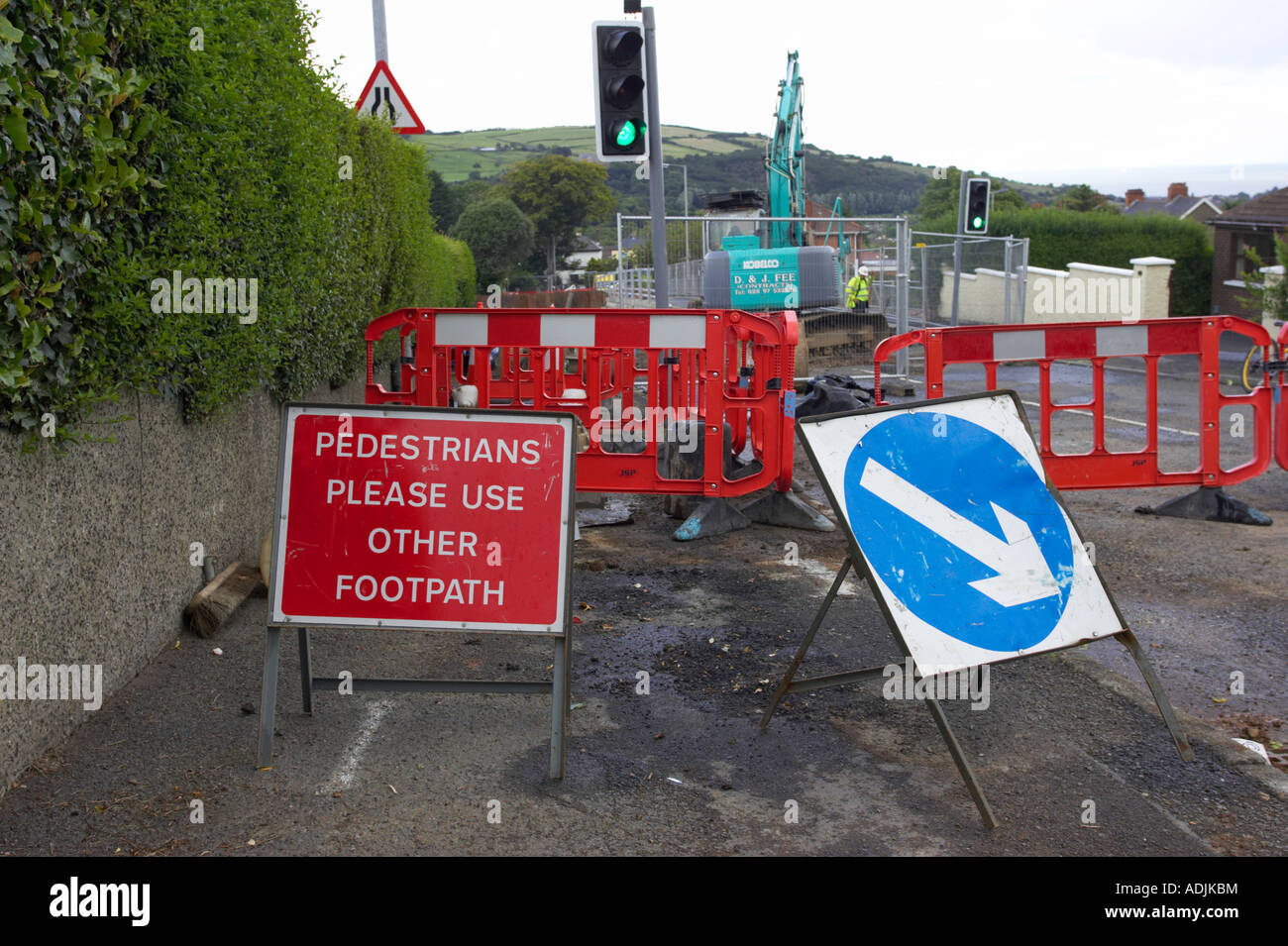 pedestrians please use other footpath and blue arrow sign at roadworks ...