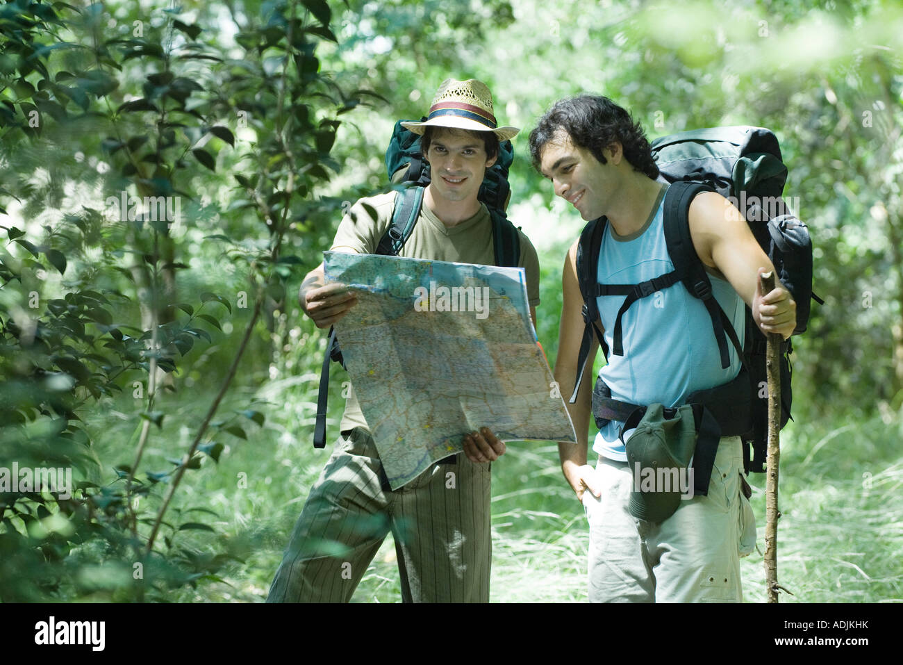 Hikers standing, looking at map Stock Photo - Alamy