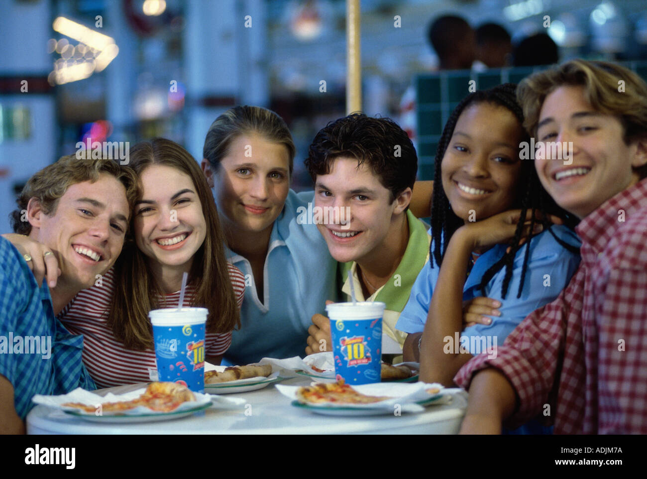 Portrait of a group of teenagers sitting in a restaurant Stock Photo ...