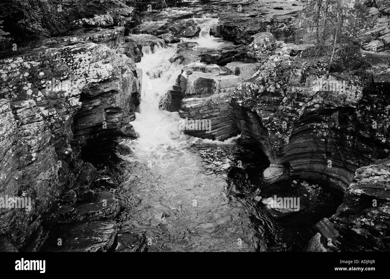 Scottish Stream around Loch Ness with eroded rock formations in black ...