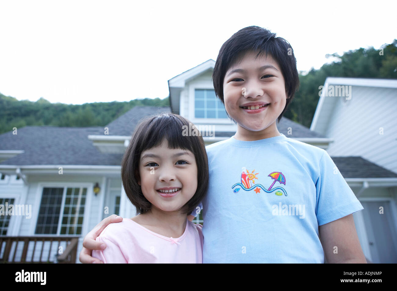 A Korean brother and sister standing with a smile Stock Photo - Alamy