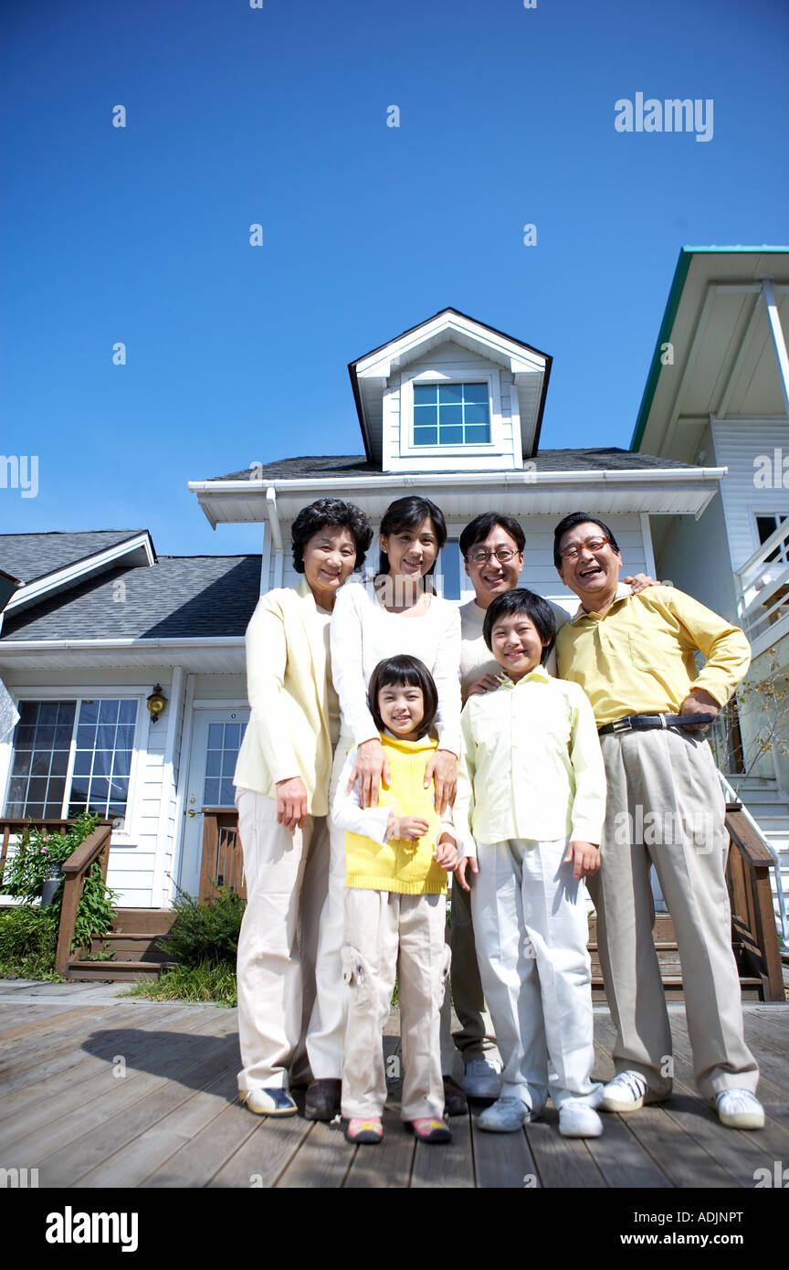 A Korean big family standing in front of the house with a smile Stock ...